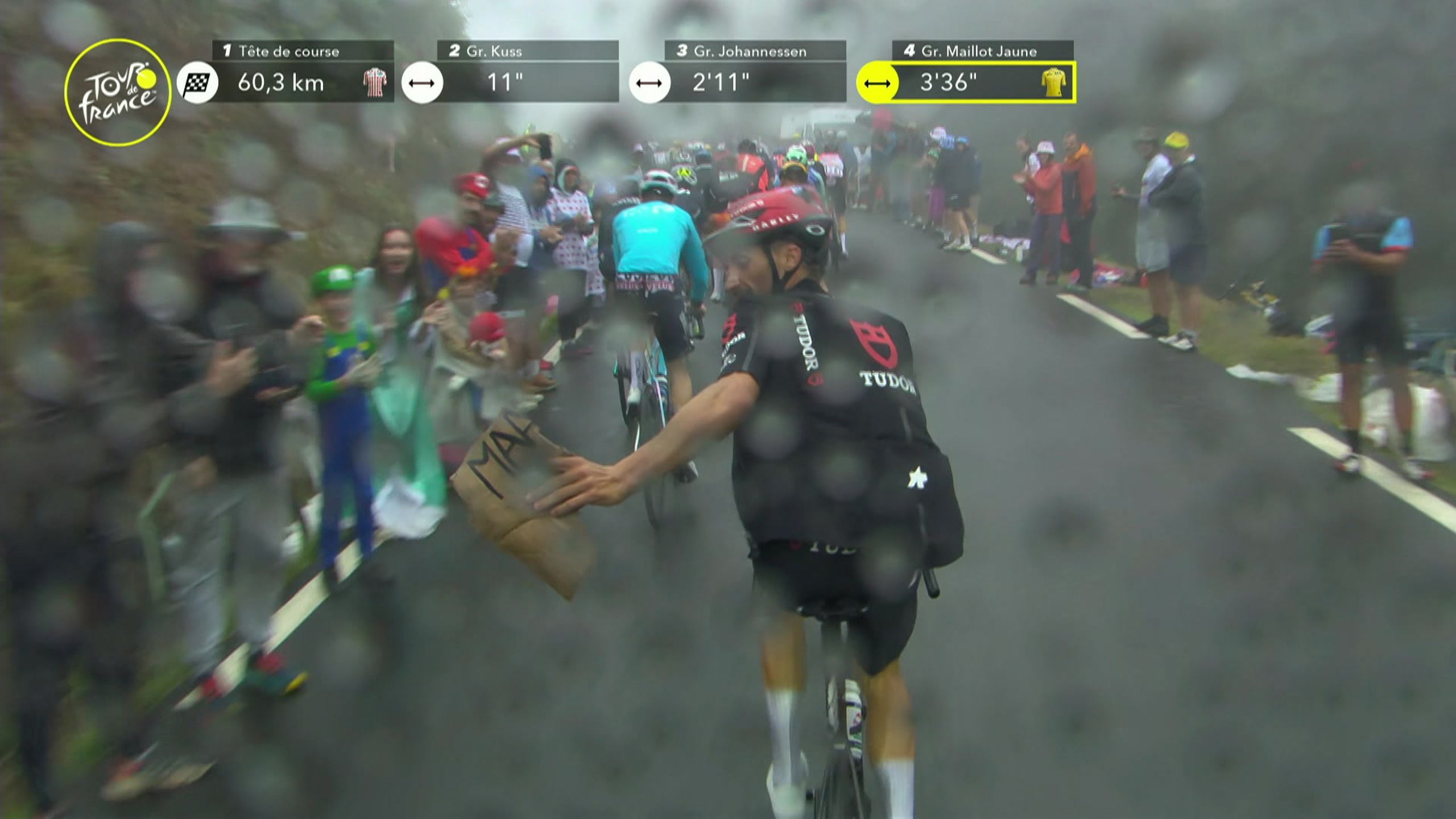 Julian Alaphilippe hands stolen, soggy cardboard sign to camera ...